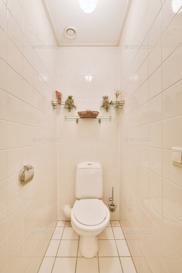 Simple narrow toilet with small sink Stock Photo by pro creator PhotoDune